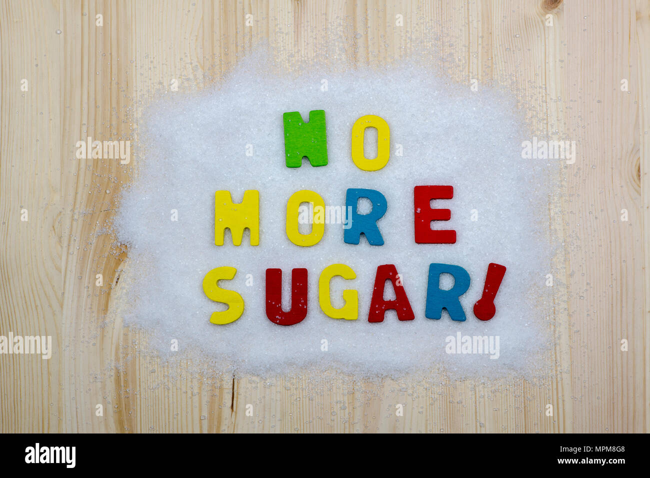 "NO MORE SUGAR!" Colorful text and letters in wood on white sugar ...