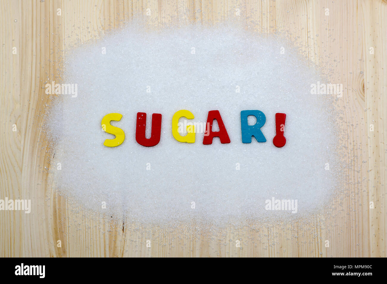 "SUGAR!" Colorful text and letters in wood on white sugar crystals ...