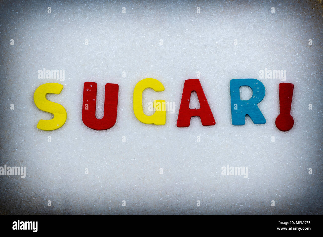 "SUGAR!" Colorful text and letters in wood on white sugar crystals ...
