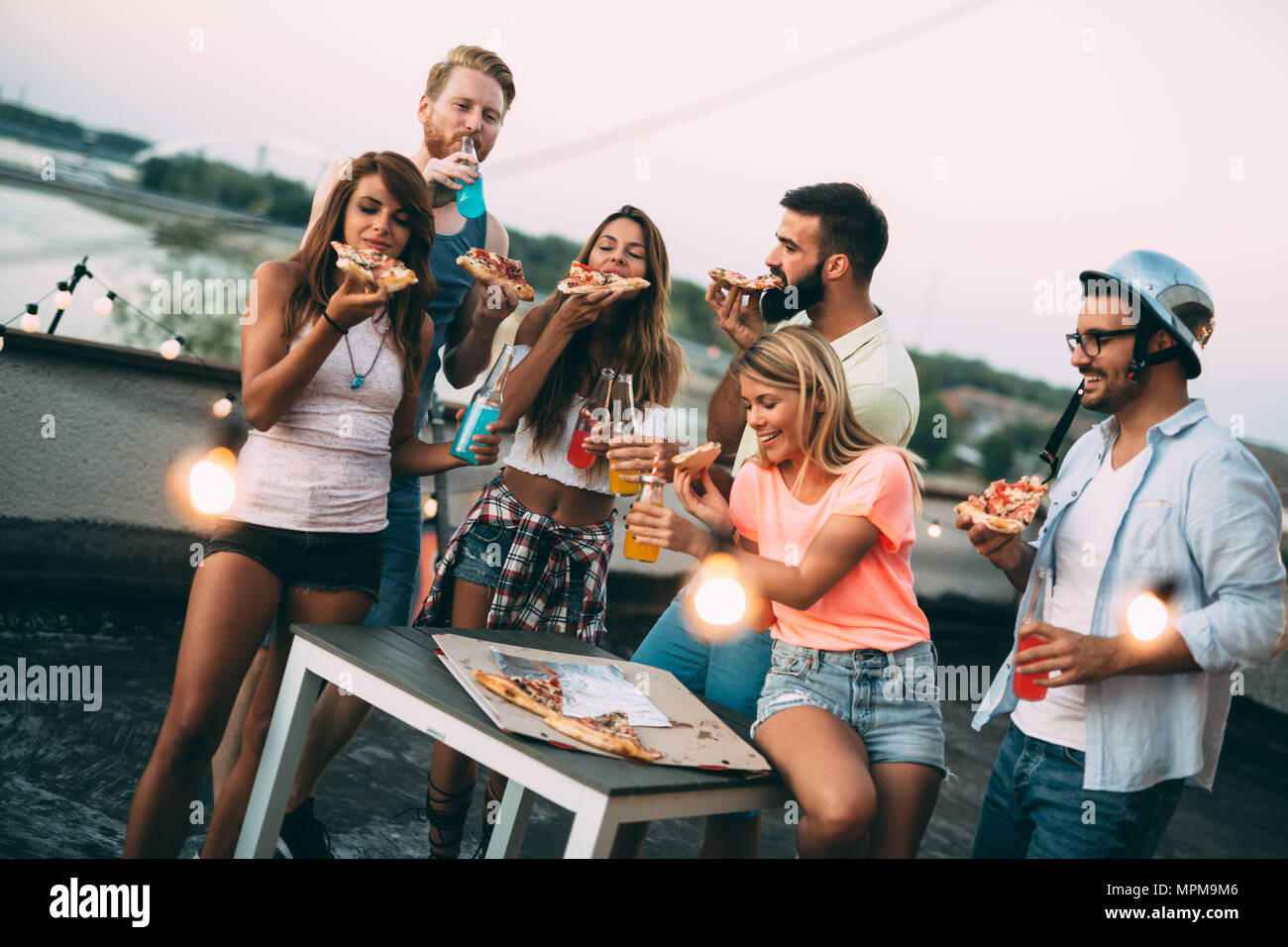 Friends having fun at rooftop party Stock Photo - Alamy