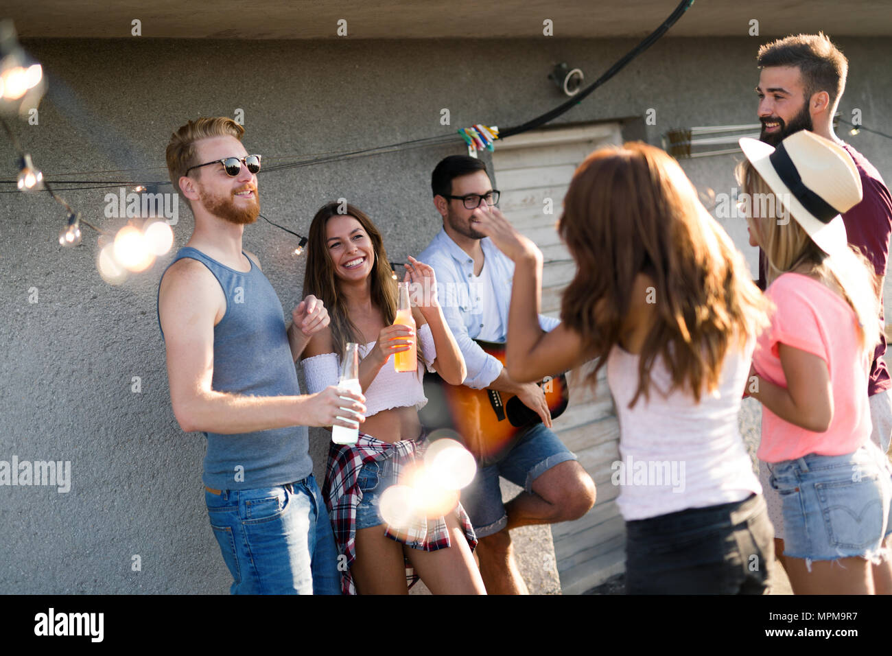 Friends having fun at rooftop party Stock Photo - Alamy