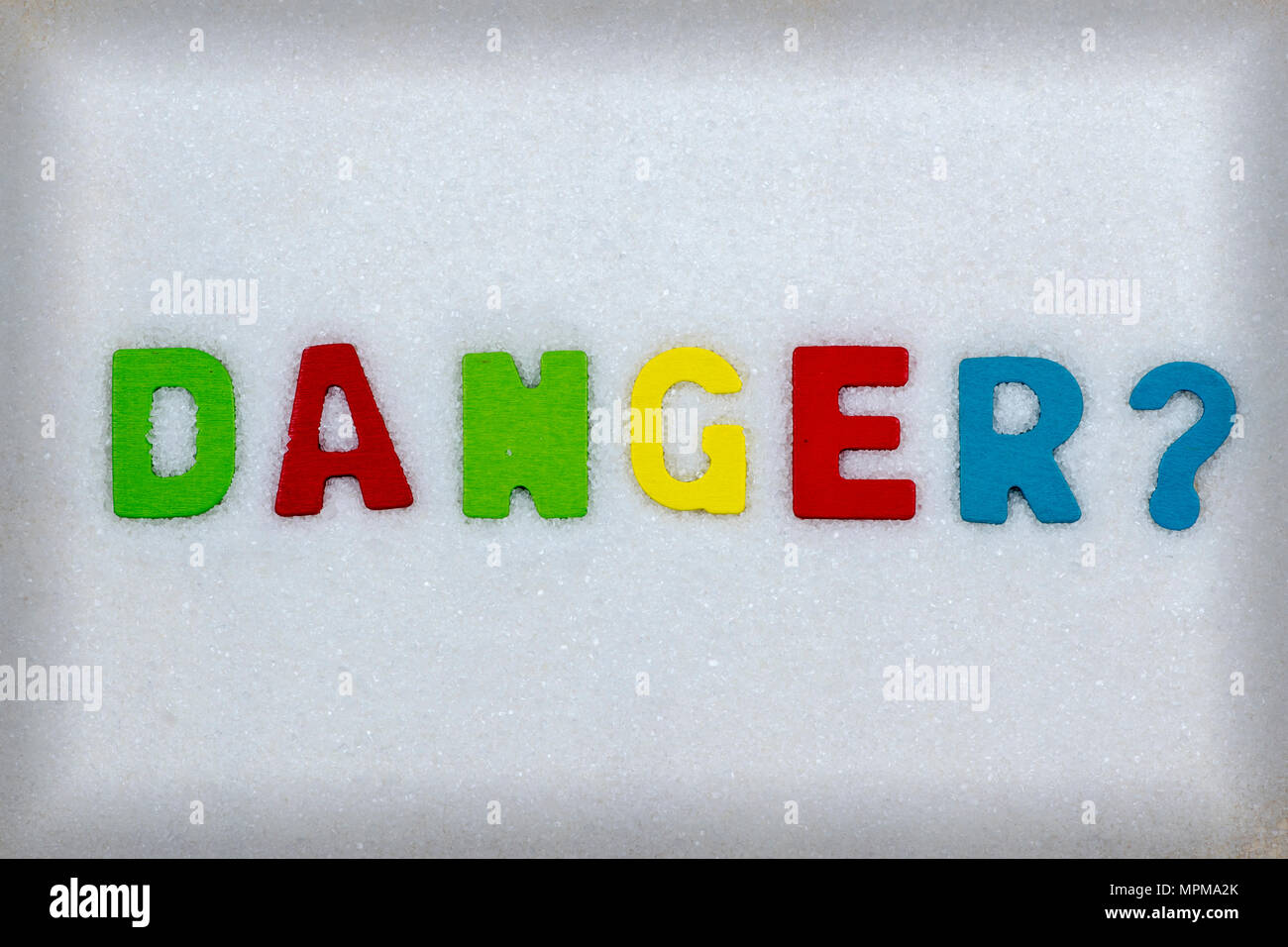 The word "Danger?" in vibrant wooden letters against a backdrop of ...