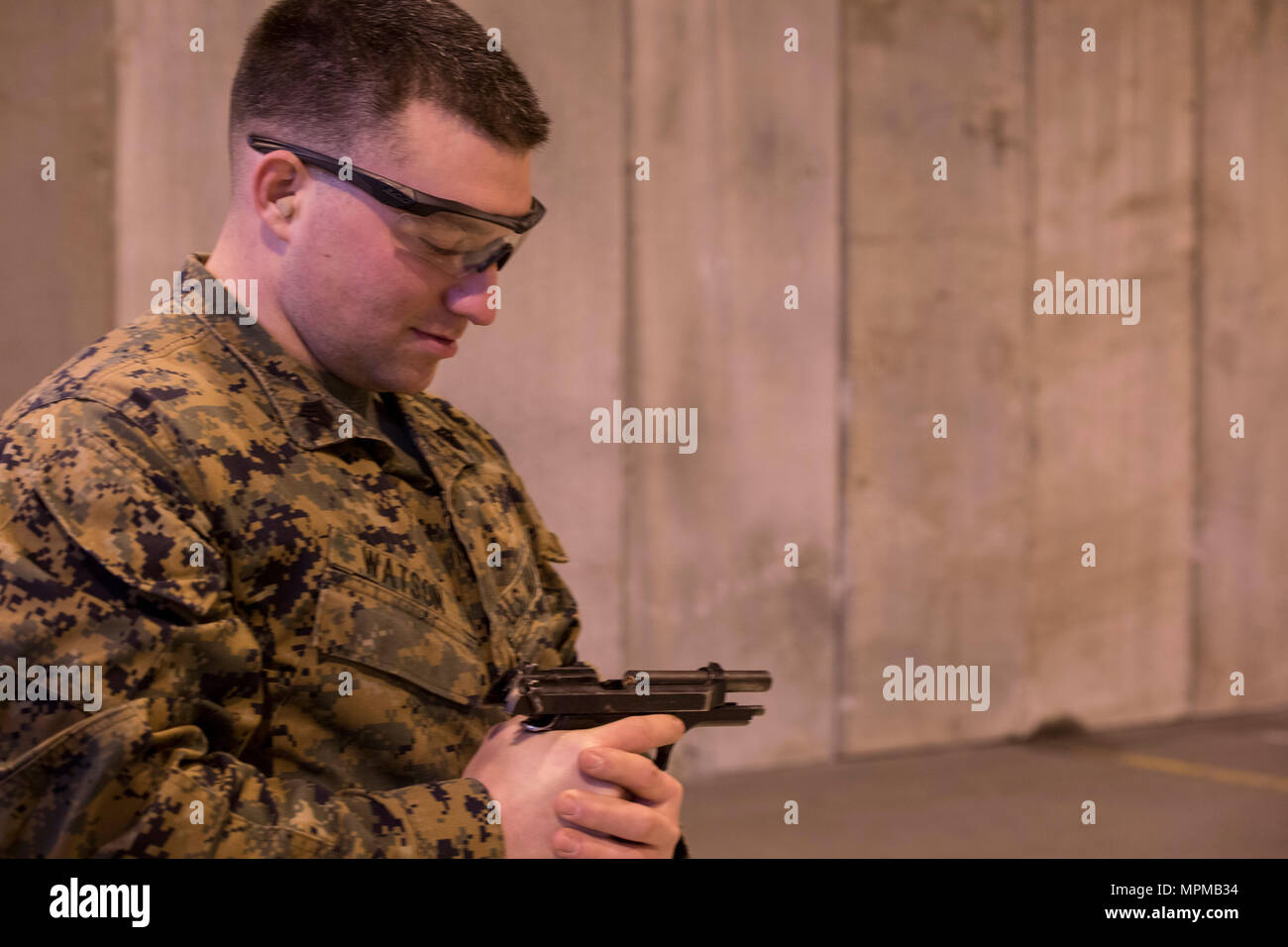 U.S. Marine Sgt. John Watson clears the M9A1 9mm service pistol during ...