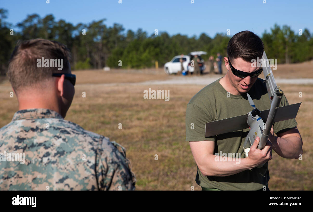 Sgt. Dillon Emery, left, and Sgt. Kyle Phillips, right, prepare a Raven ...