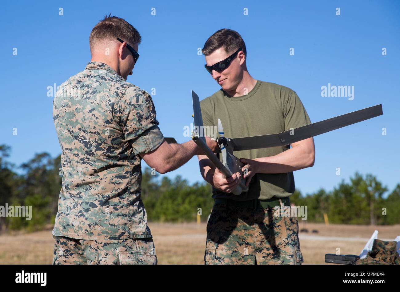 Sgt. Dillon Emery, left, and Sgt. Kyle Phillips, right, construct a ...