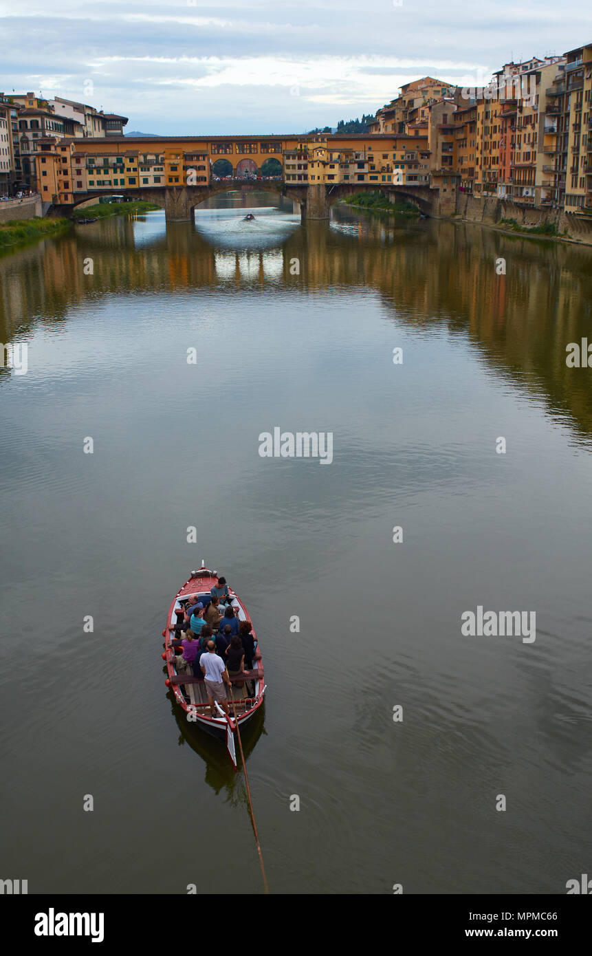 FLORENCE, ITALY-JULY 3, 2013: Tourists enjoy a morning boat ride on the ...