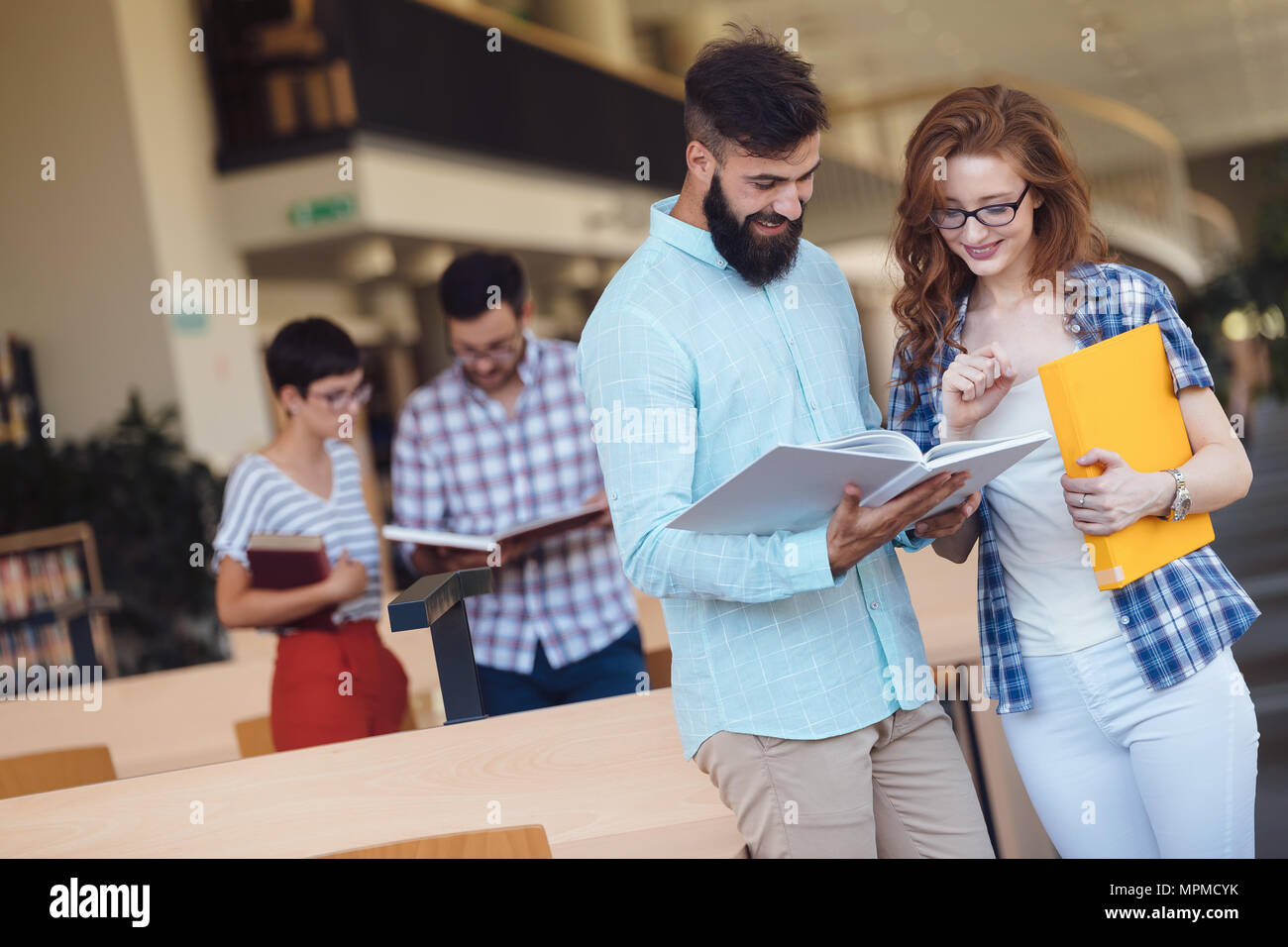Happy students couple in school library have discussion Stock Photo - Alamy