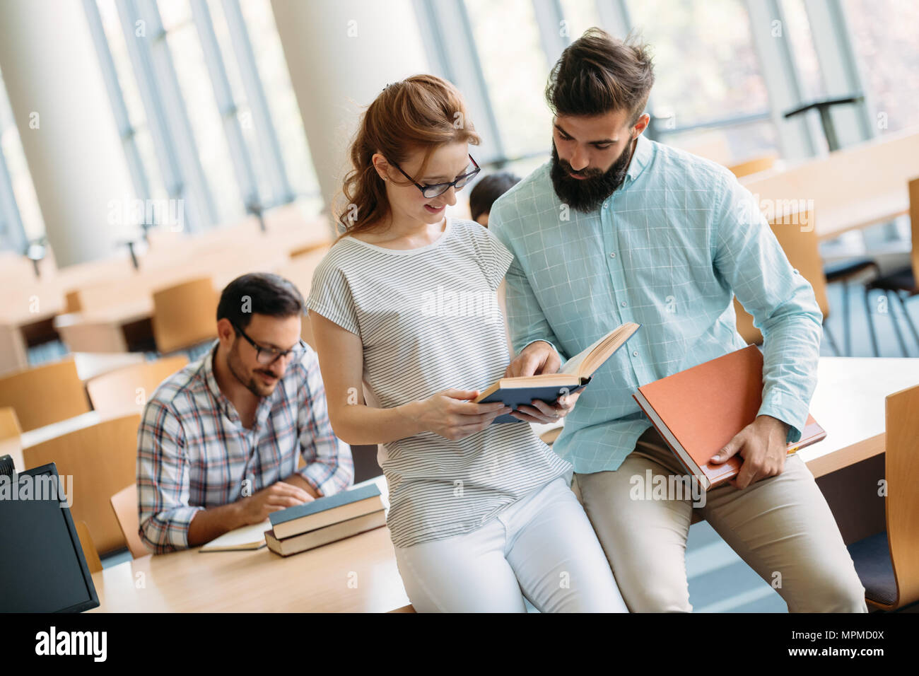 Group of young students studying together Stock Photo - Alamy