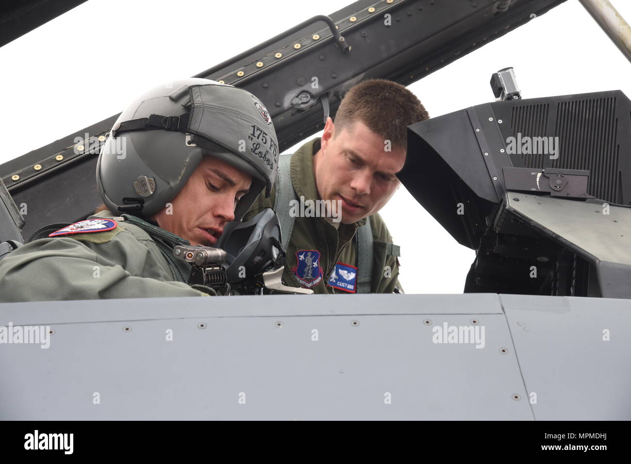 Capt. Casey Minor, 175th Fighter Squadron pilot, explains the controls ...