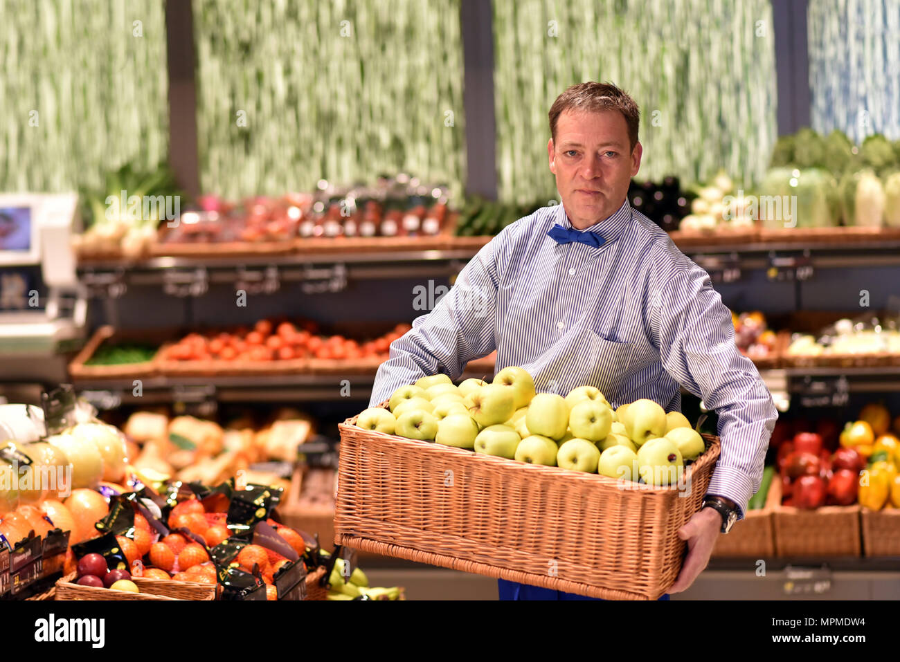 older seller with a staircase of apples in the supermarket - sale of ...