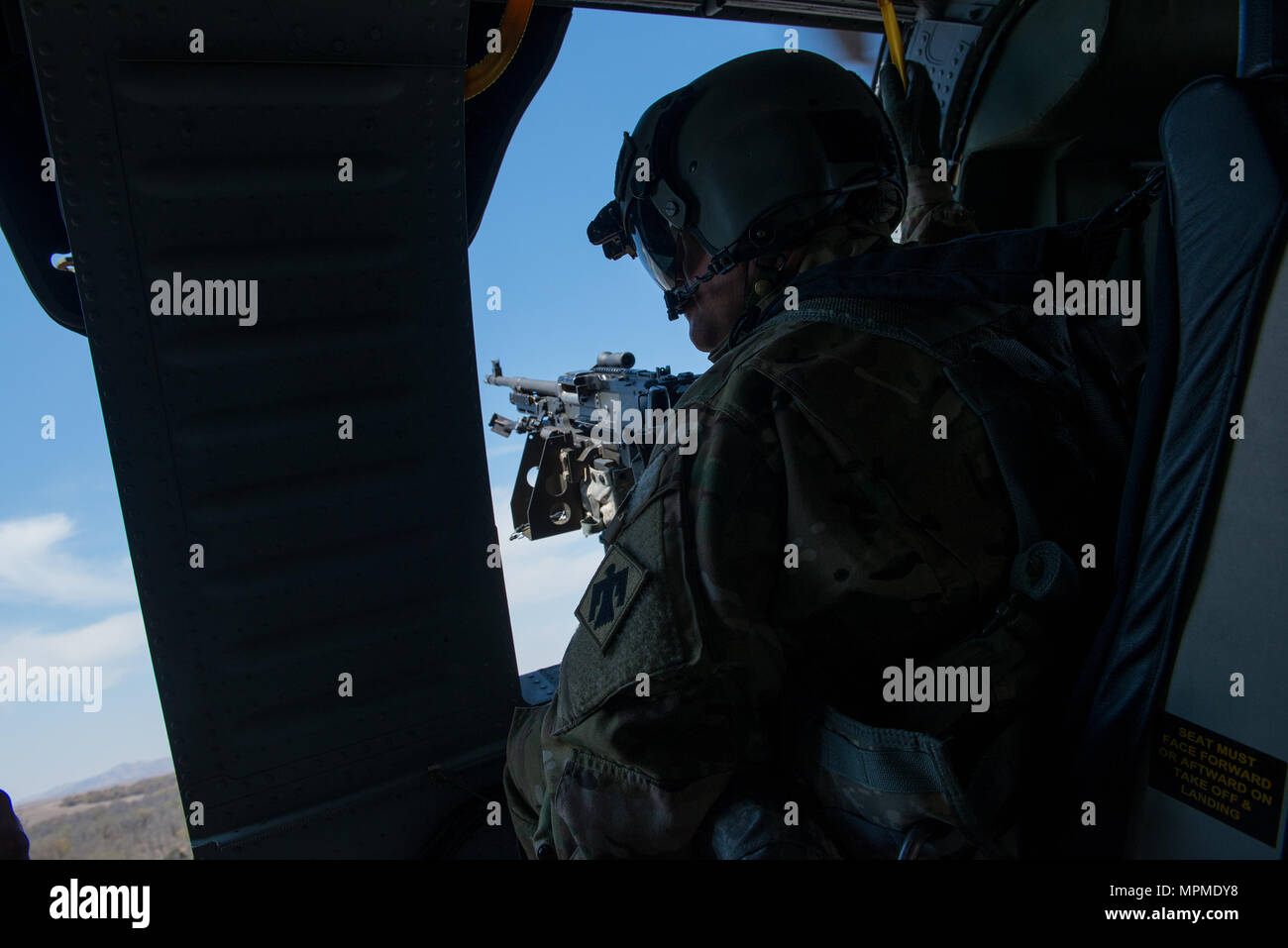 A door gunner on a UH-60 Black Hawk helicopter from the 244th Aviation ...