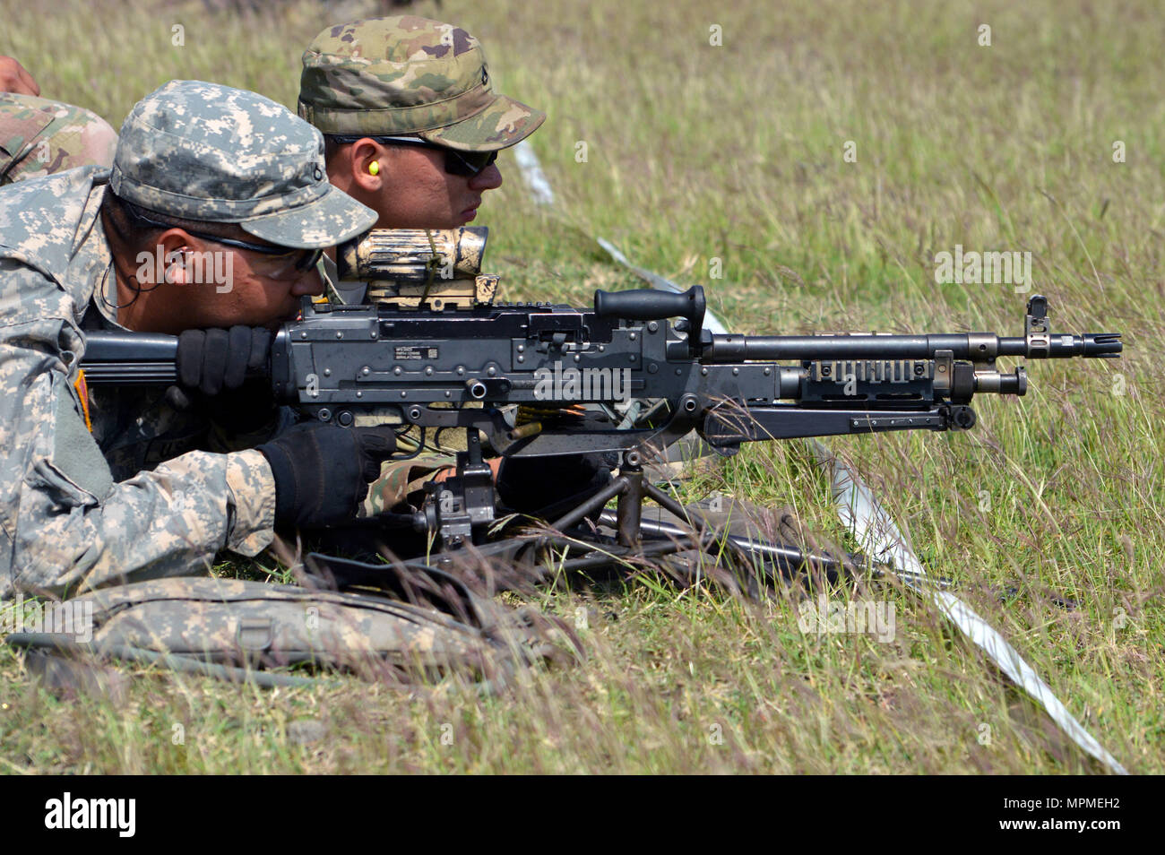 Pfc. Jesse Martinez fires an M240 Machine Gun while his assistant ...