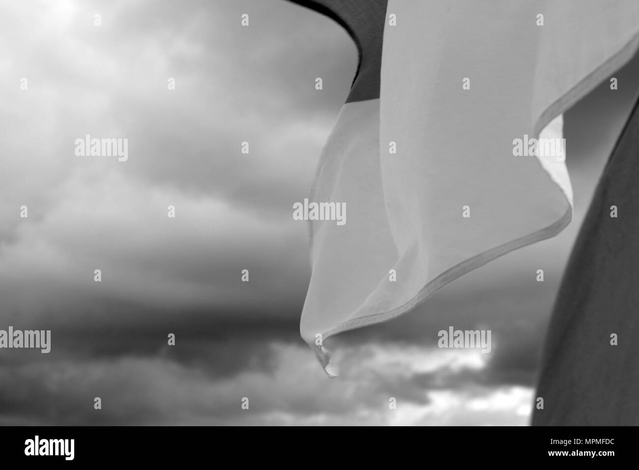 Red & Yellow RNLI Safety Flags on the beach with cloudy blue skies ...