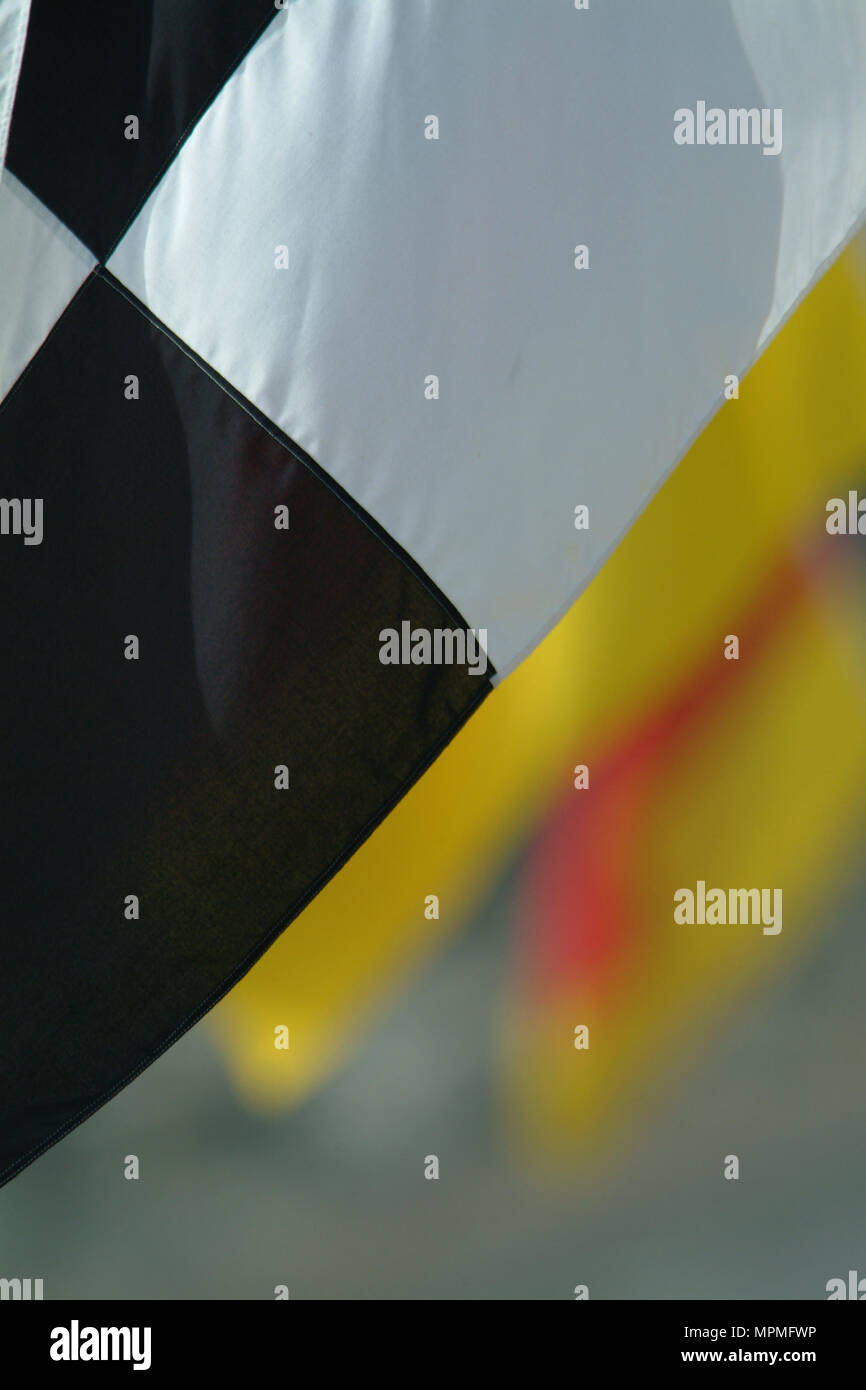 Red & Yellow RNLI Safety Flags on the beach with cloudy blue skies ...