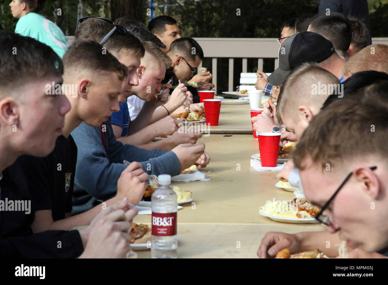 Marines and their families gather and eat food at the annual Pig Pickin ...