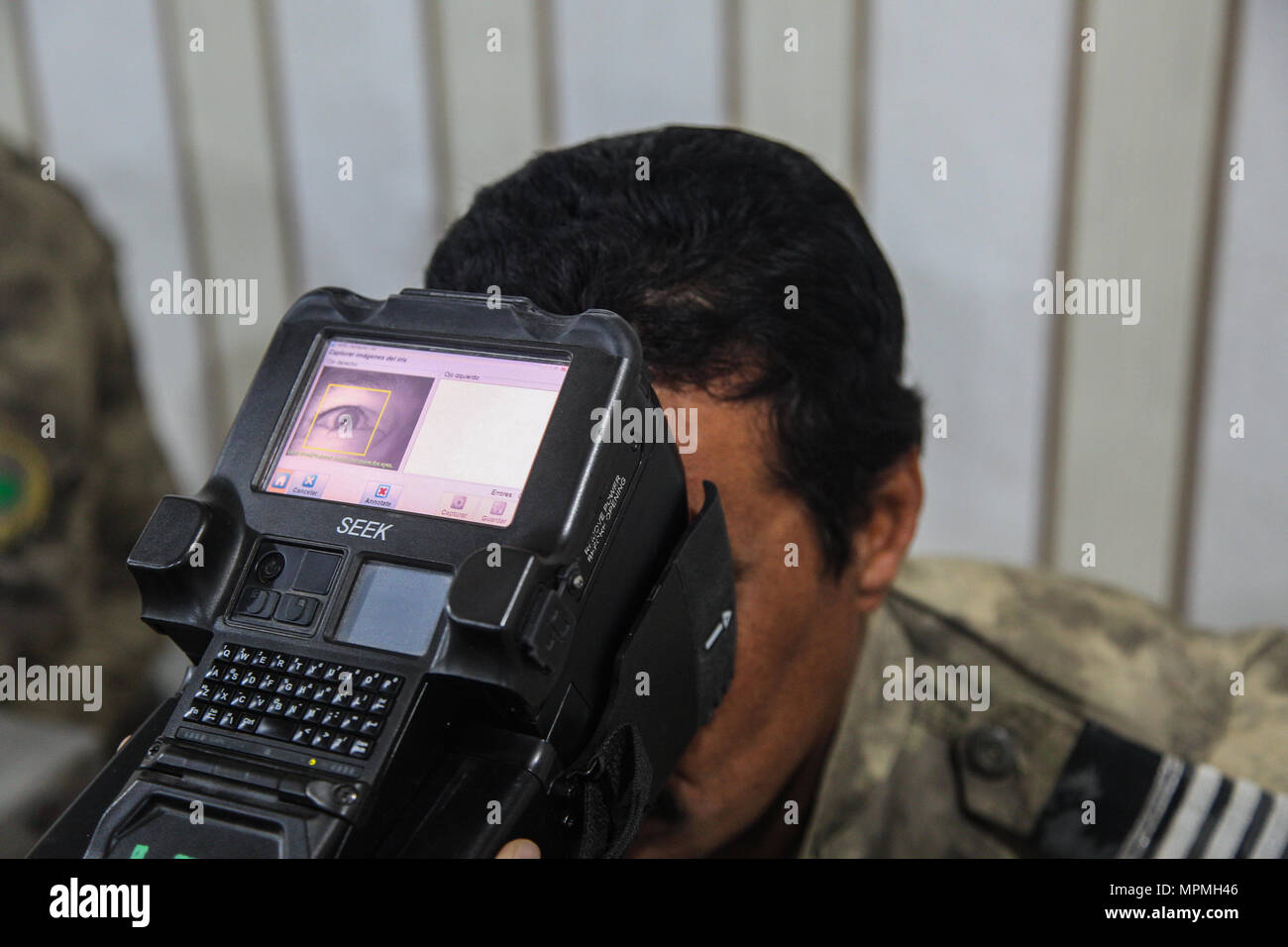 An Iraqi security forces soldier undergoes a retinal scan during in ...