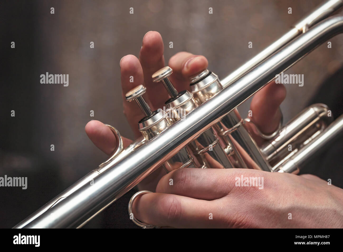 Hand of the Trumpeter on the buttons of the trumpet Stock Photo - Alamy