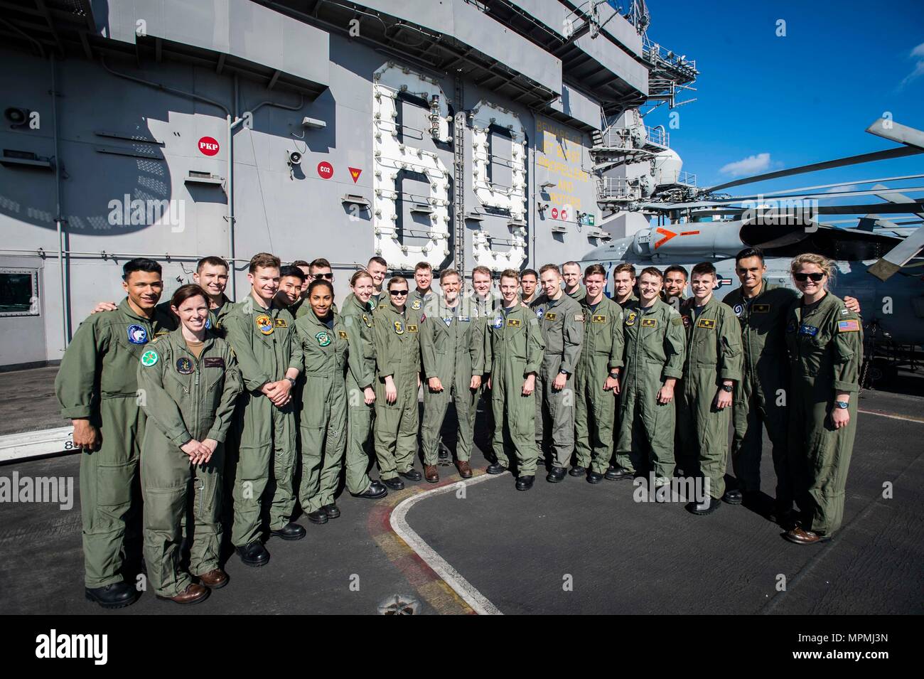 Midshipmen pose for a picture on the flight deck of USS Dwight D ...