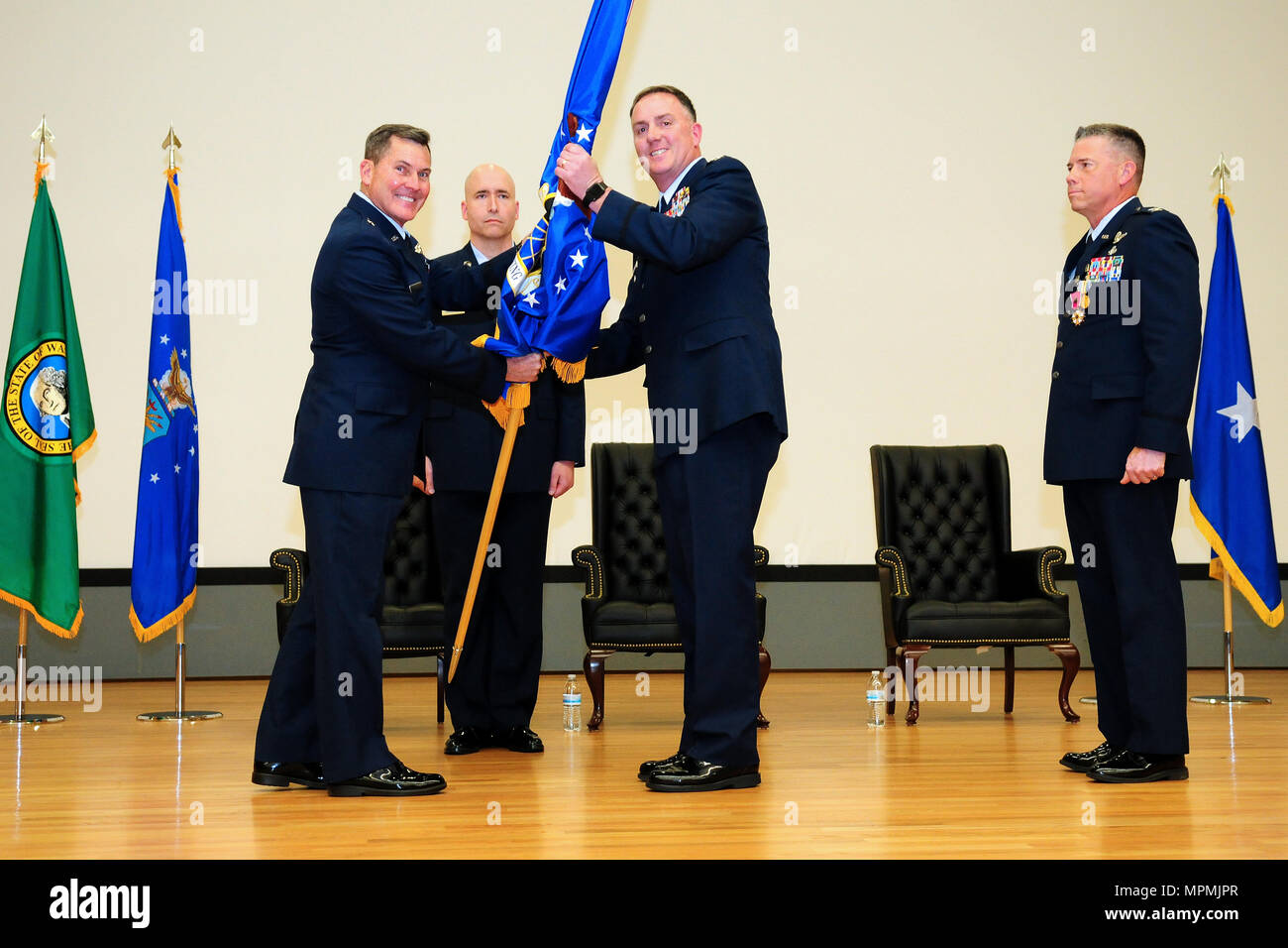 Washington Air National Guard Commander Brig. Gen. John Tuohy hands the ...