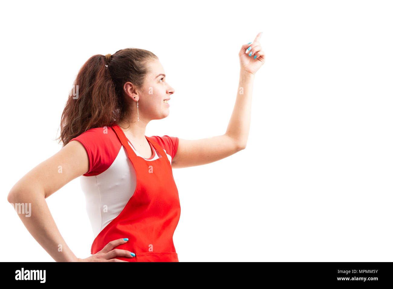 Young female supermarket employee pointing up at empty area as ...