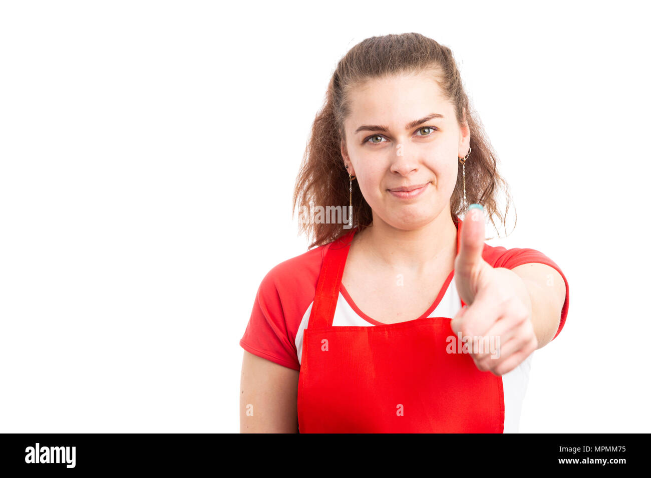 Young female supermarket employee showing thumbs up like gesture as ...