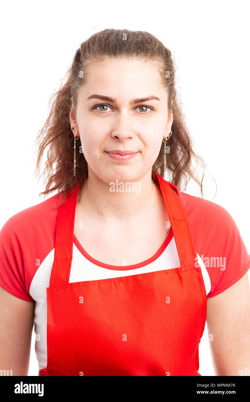 Portrait of young female supermarket employee wearing red apron ...