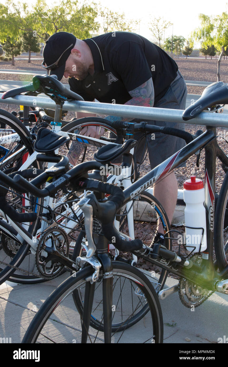 Eric Turnbaugh, U.S. Army Adaptive Sports Coach for Cycling, checks the ...