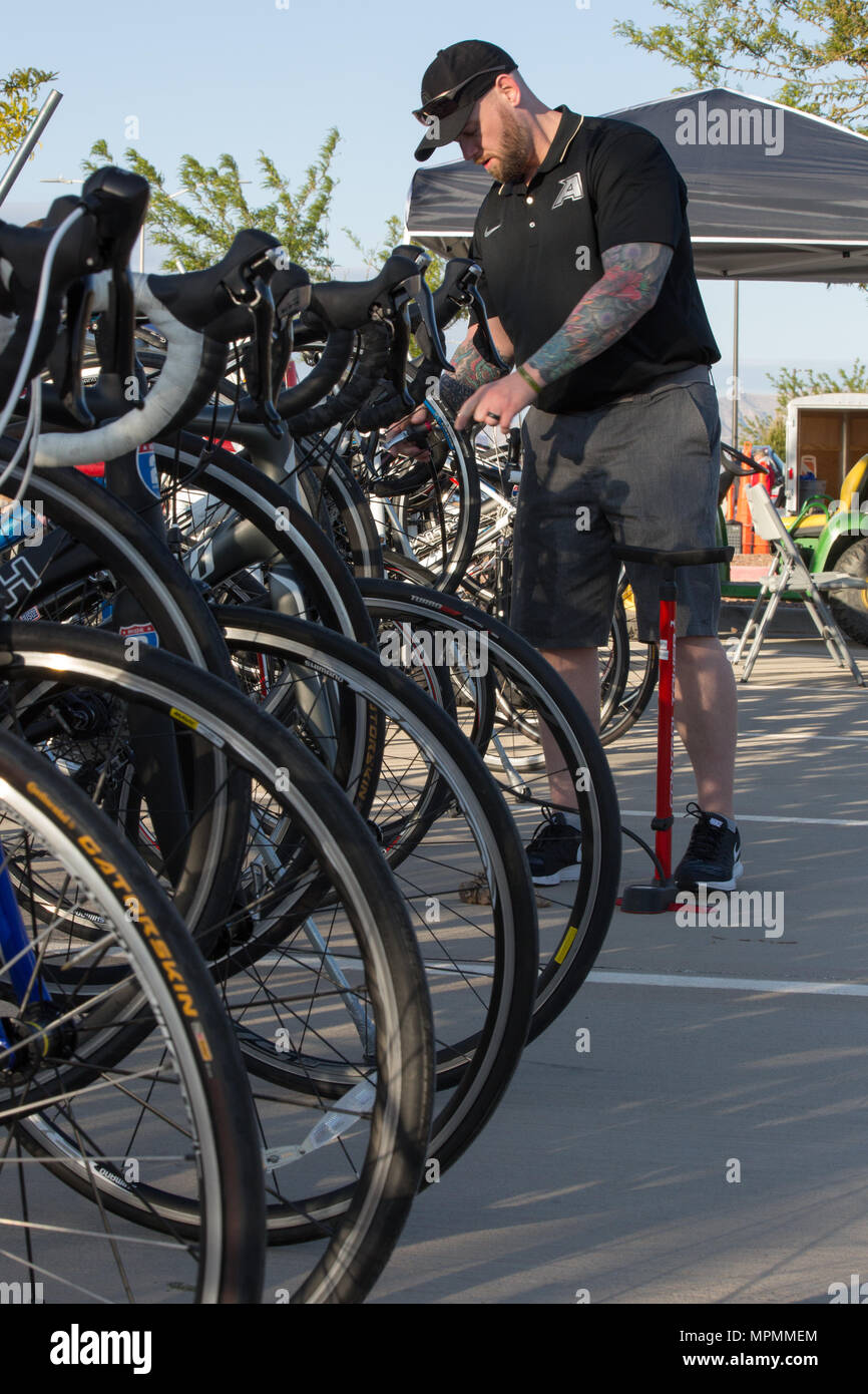 Eric Turnbaugh, U.S. Army Adaptive Sports Coach for Cycling, checks the ...