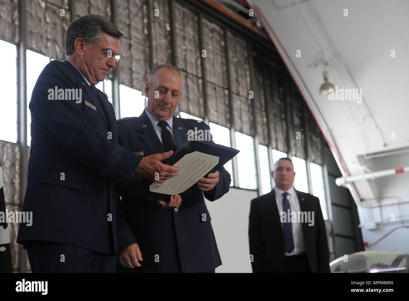 Maj. Gen. H. Michael Edwards is presented a certificate of appreciation ...