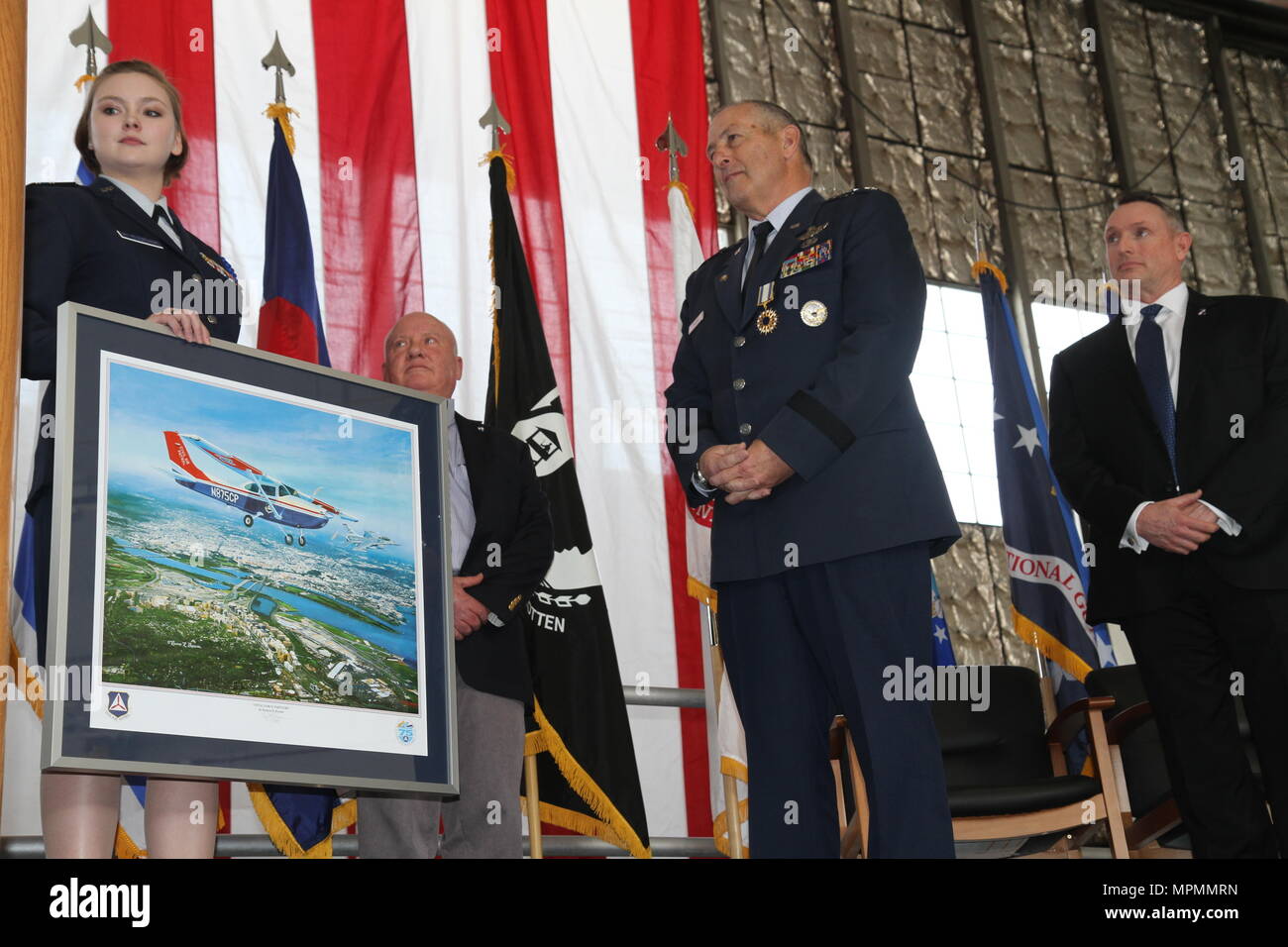 Maj. Gen. H. Michael Edwards is presented a piece of artwork from the ...
