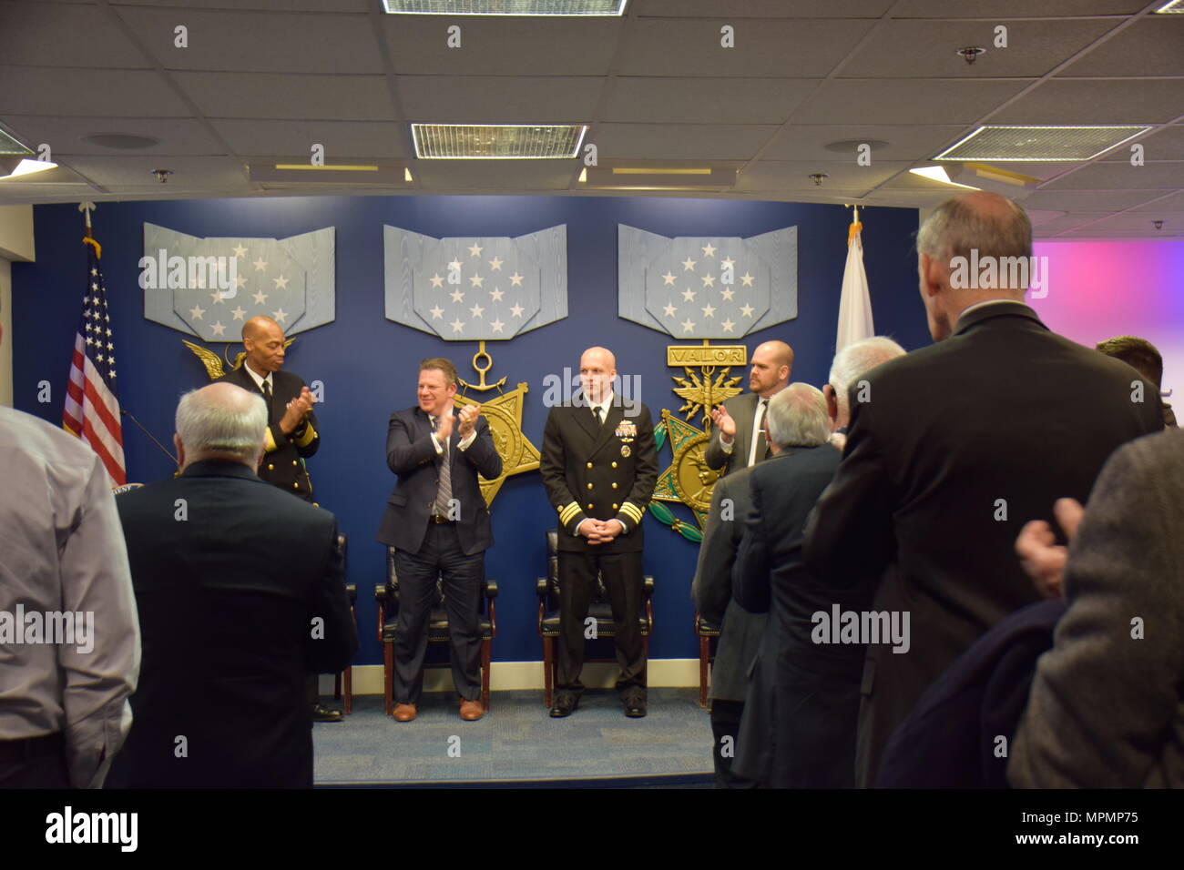 Cmdr. Michael Adams retires during a ceremony attended by family ...