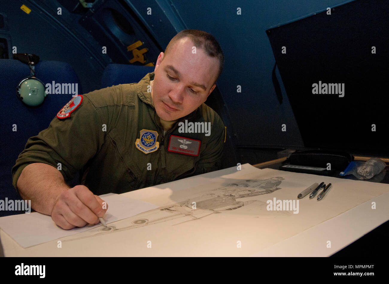 Tech Sgt. Timothy McCarthy, 22nd Airlift Squadron, adds details to a ...