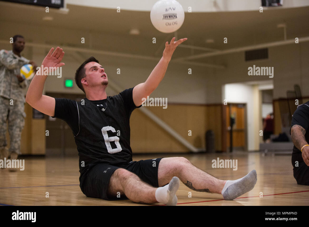 U.S. Army veteran, Laramie Dockery, serves the ball for the sitting ...