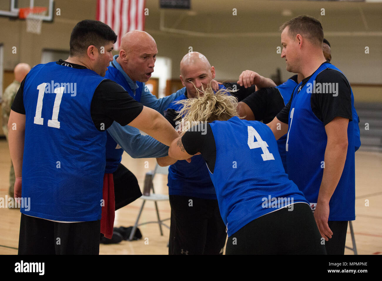 U.S. Army Soldiers and veterans huddle during training for sitting ...