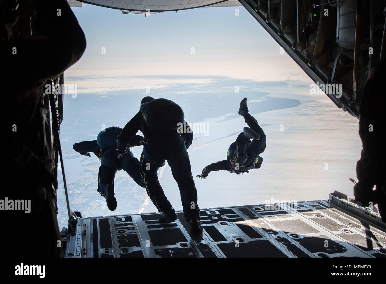 Members of the U.S. Navy Leap Frogs jump from an 815th Airlift Squadron ...