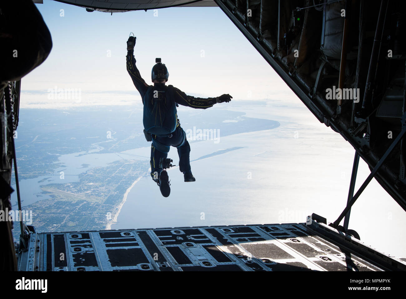 A member of the U.S. Navy Leap Frogs jumps from an 815th Airlift ...