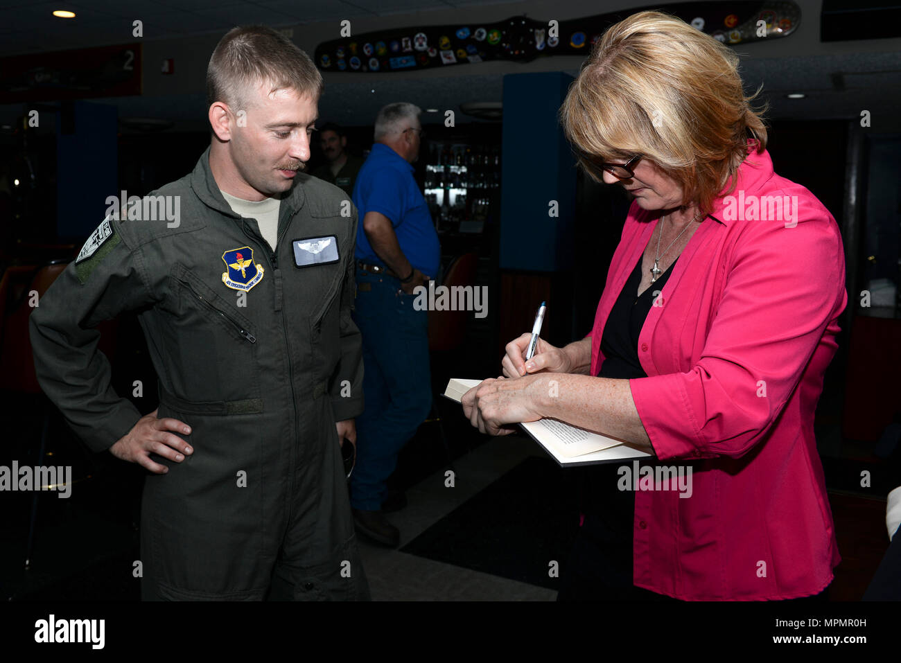 Christina Olds, daughter of retired Brig. Gen. Robin Olds, signs an ...