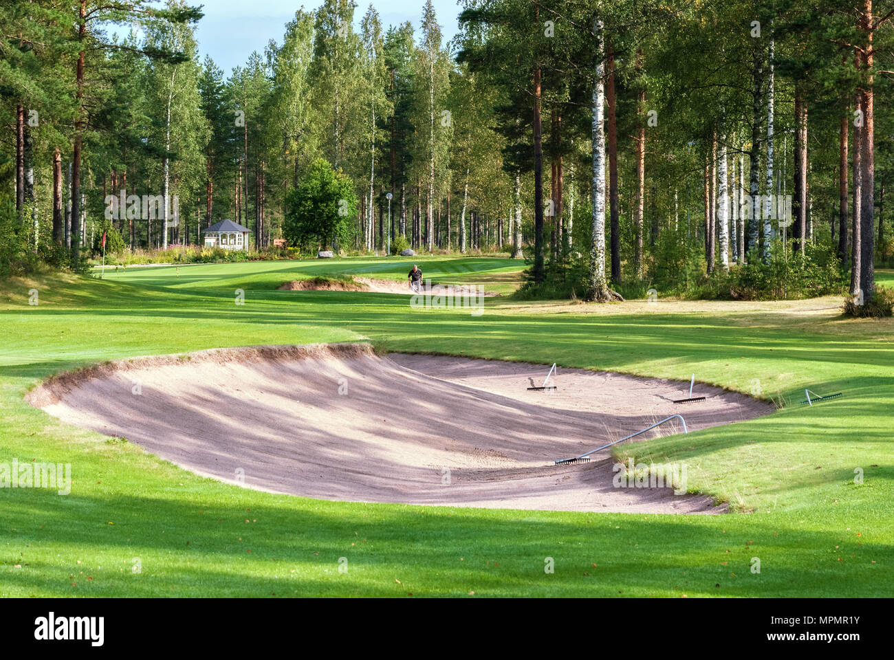 A green golf course with sand pit sections in the sports complex of ...