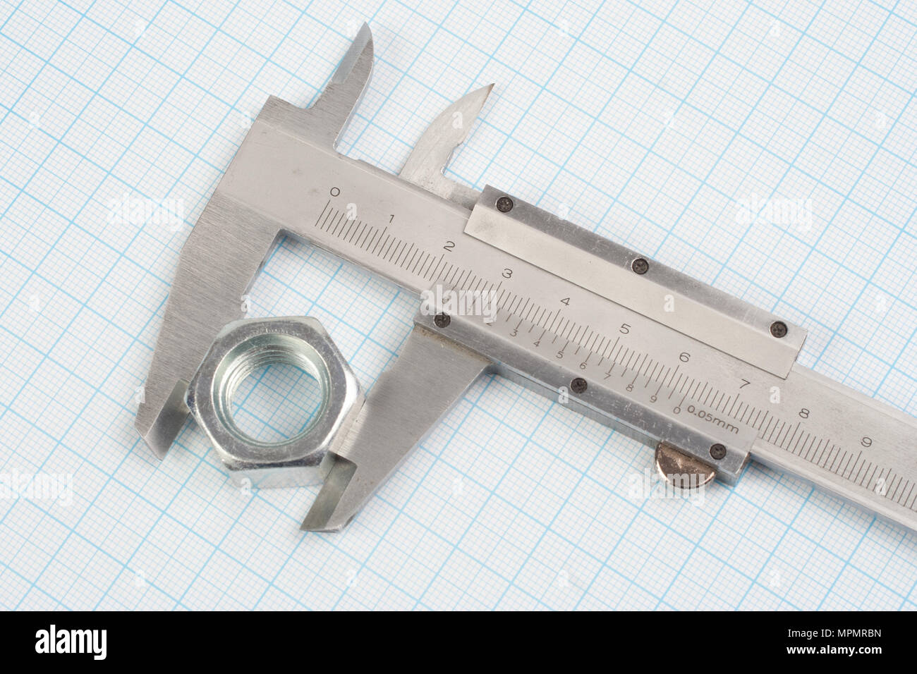 Screw, Nuts and caliper on graph paper background Stock Photo - Alamy