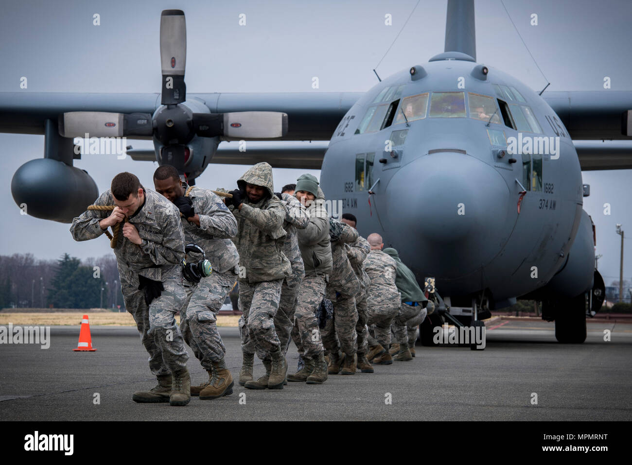 Members of the 374th Aircraft Maintenance Squadron pull a C-130H ...