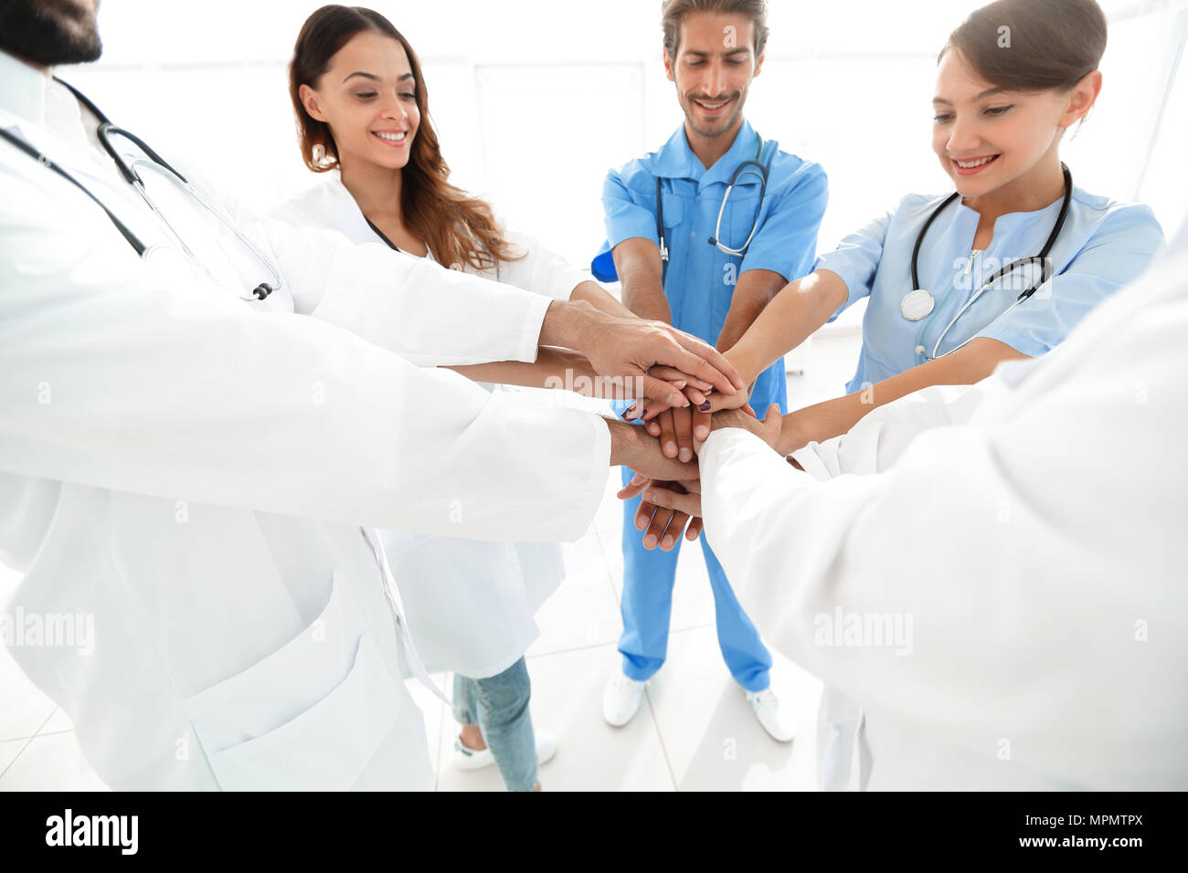 Doctors and nurses in a medical team stacking hands Stock Photo - Alamy
