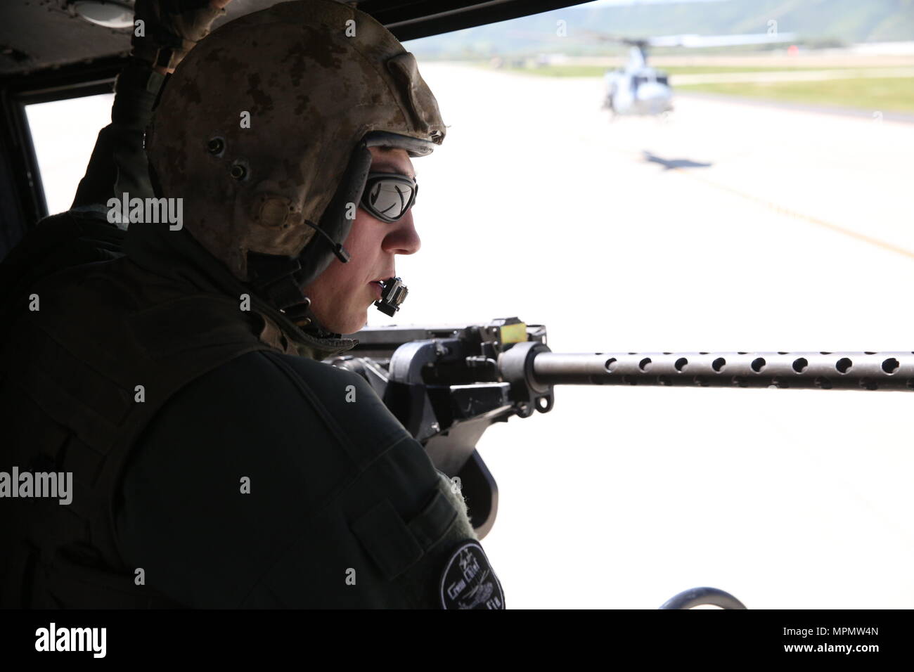 A crew chief with Marine Light Attack Helicopter Squadron (HMLA) 369 ...