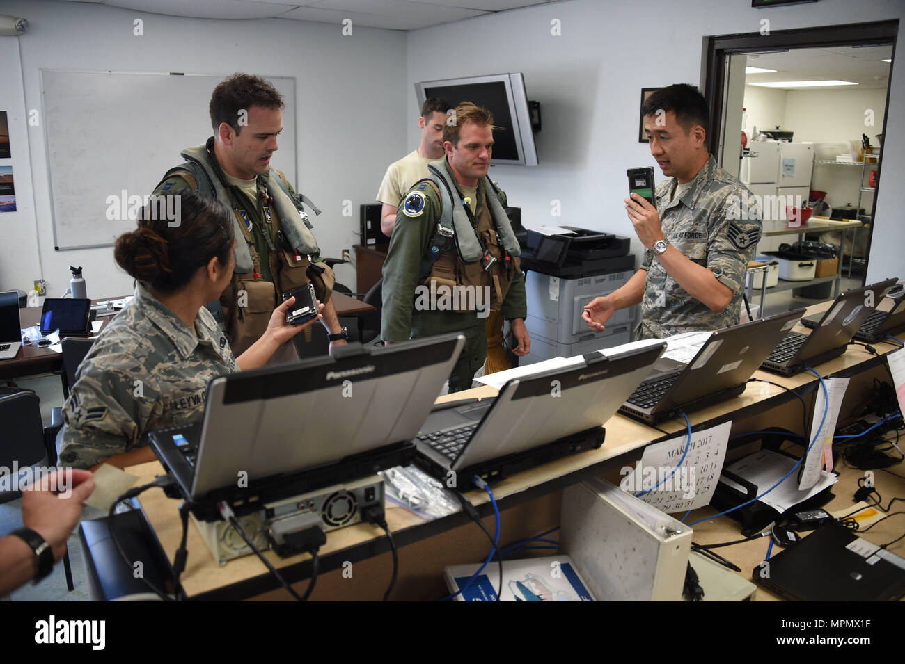 Members of the 144th Maintenance Operations Flight debrief 194th ...