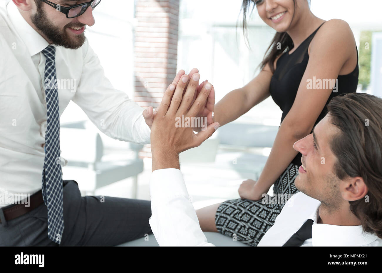 members of the business team give each other high five Stock Photo - Alamy