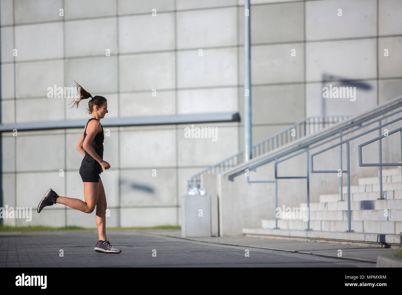 Female Urban Runner training on Concrete stairs Stock Photo - Alamy