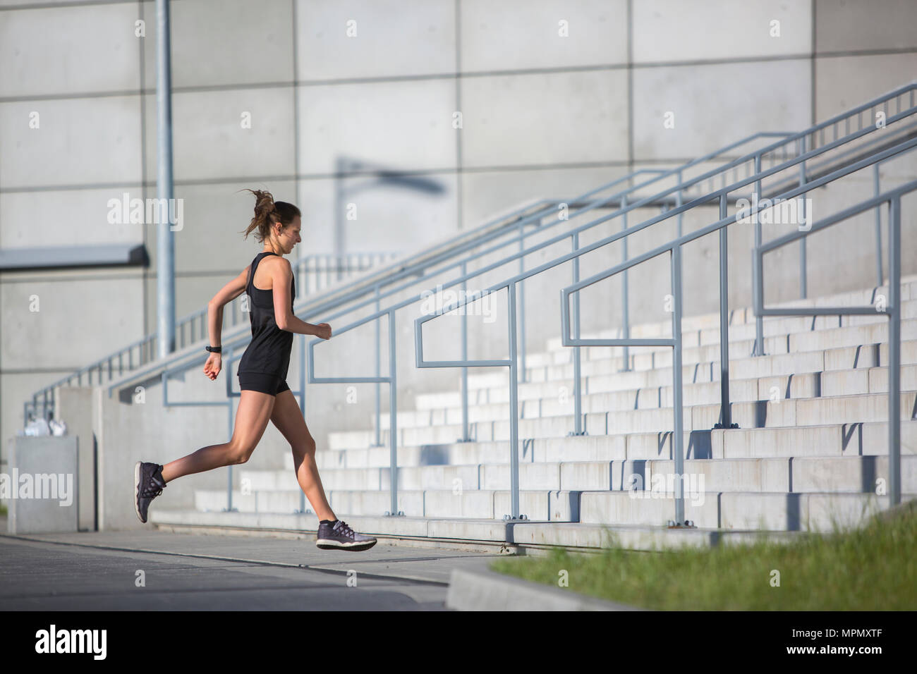 Female Urban Runner training on Concrete stairs Stock Photo - Alamy