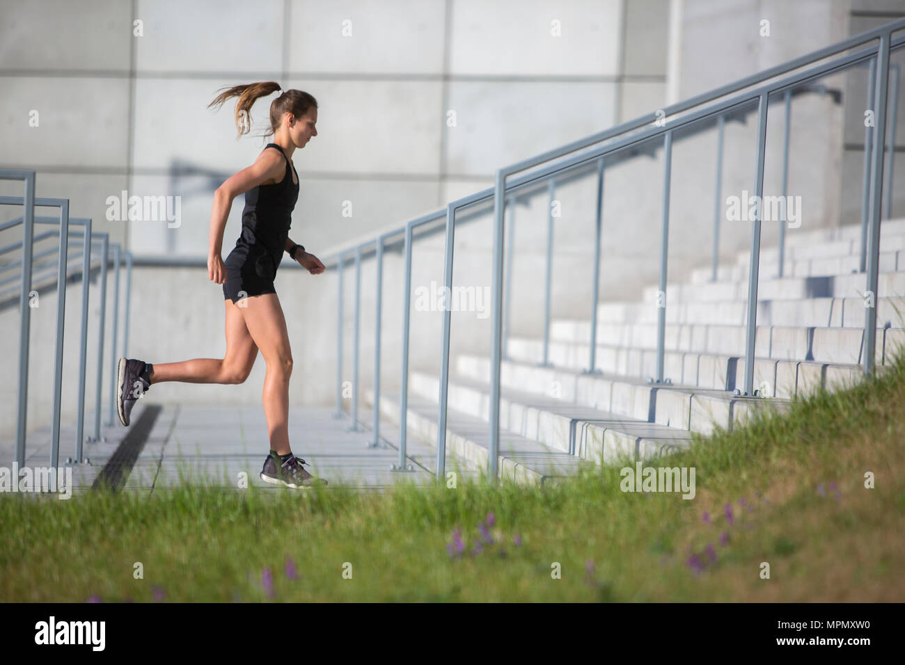Female Urban Runner training on Concrete stairs Stock Photo - Alamy