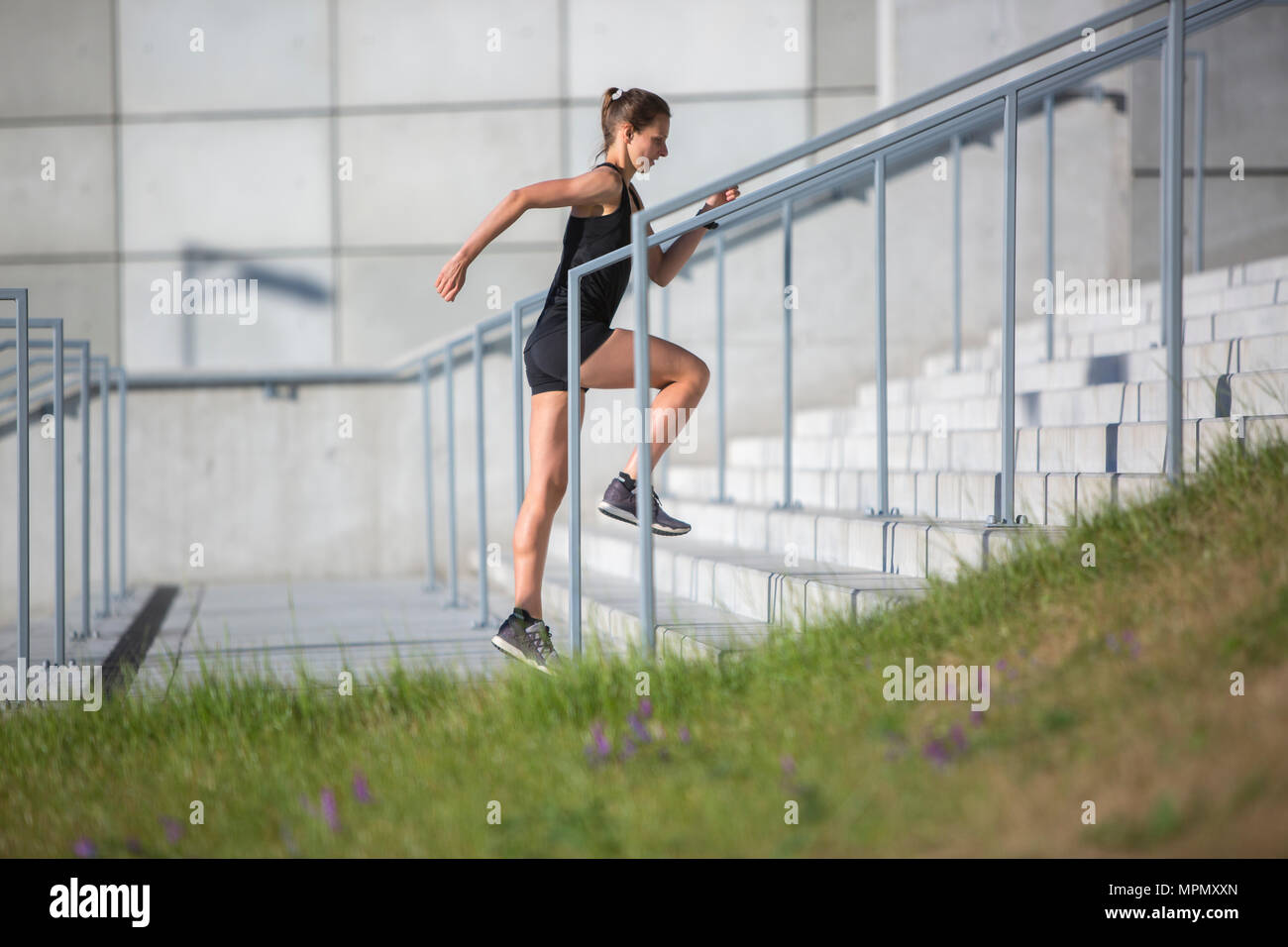 Female Urban Runner training on Concrete stairs Stock Photo - Alamy