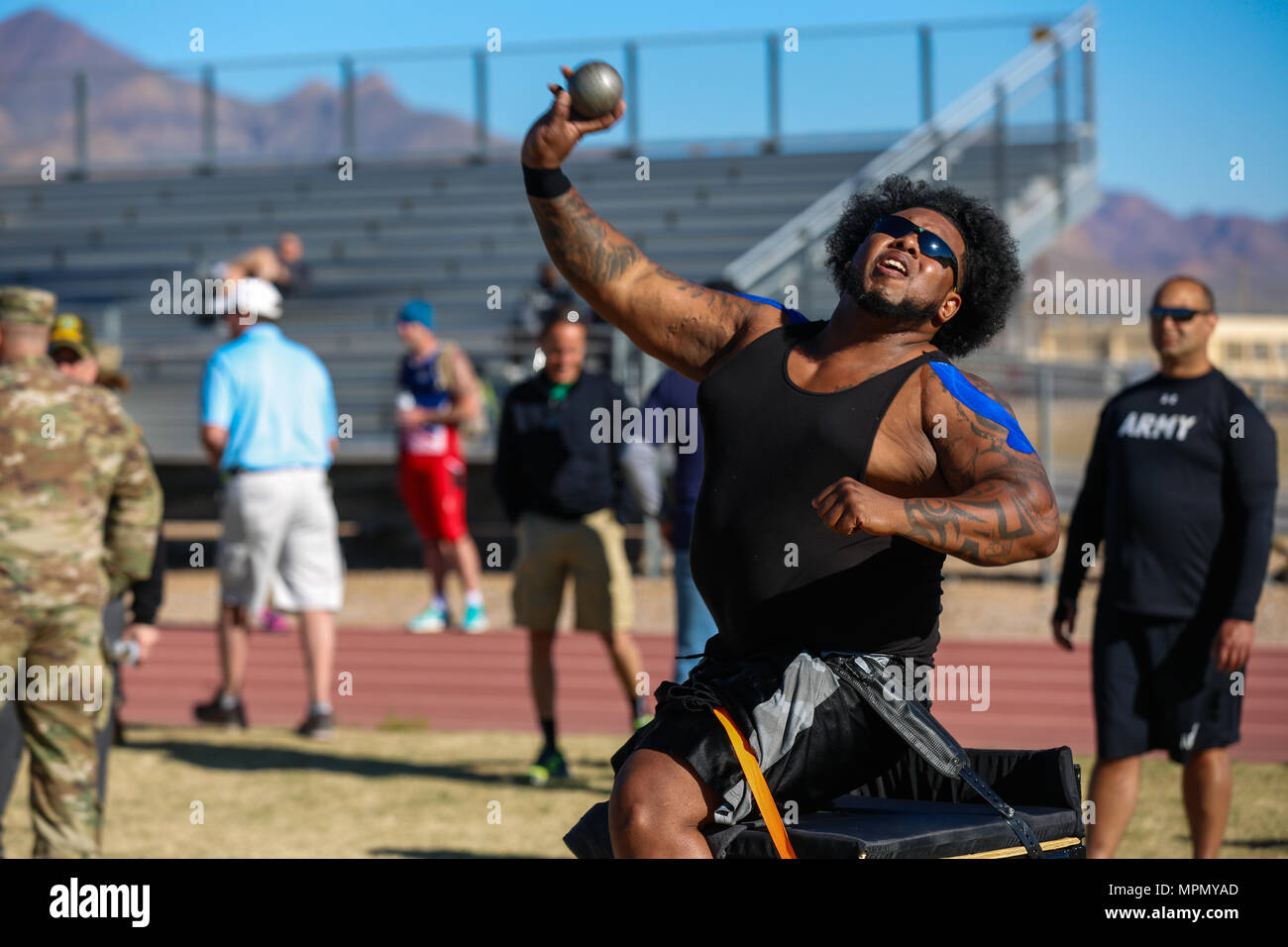 U.S. Army veteran, Isaac Rios, throws in the sitting shot put event for ...