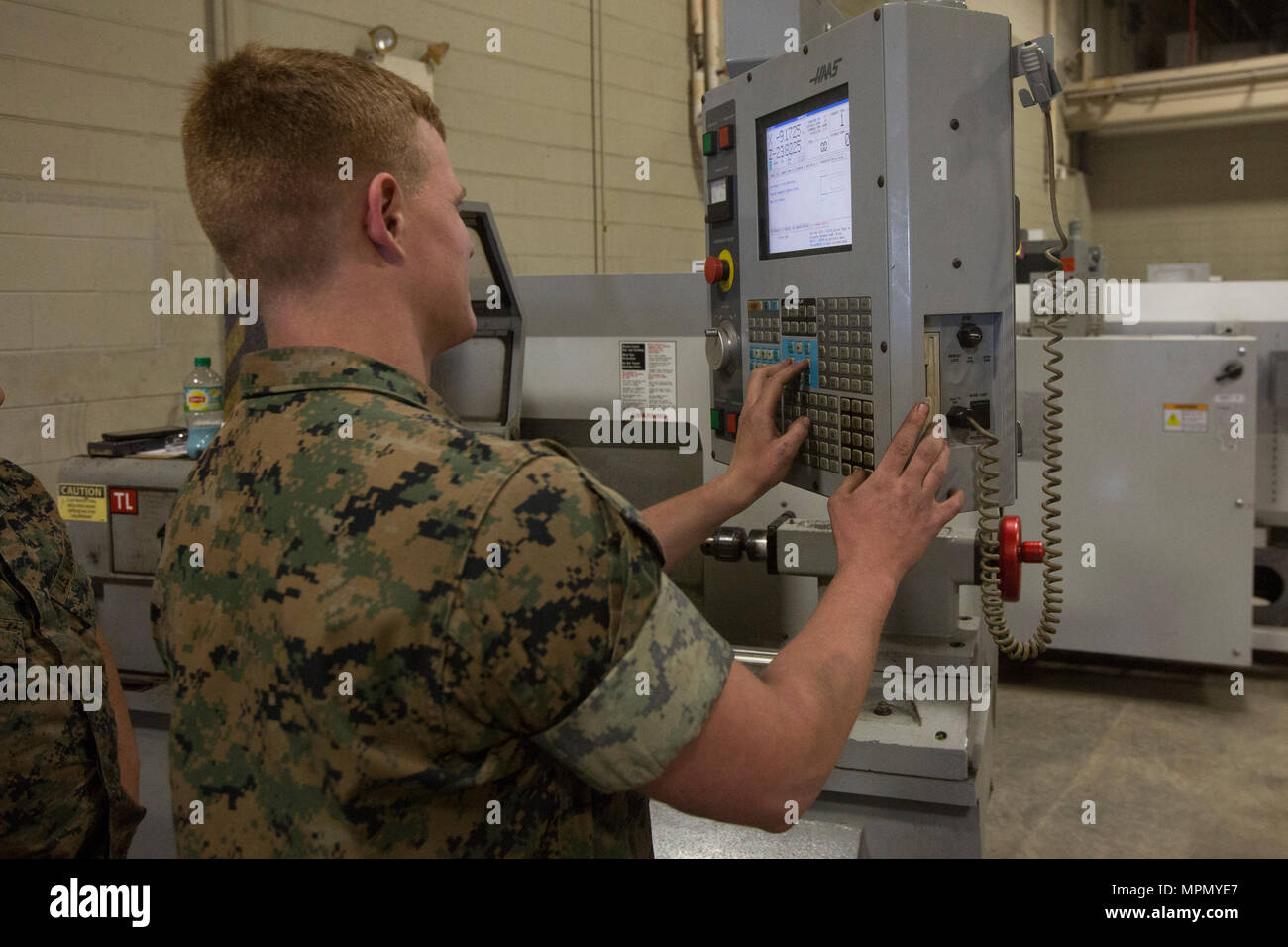 A U.S. Marine demonstrates how to use a 3d printer during a brief on ...